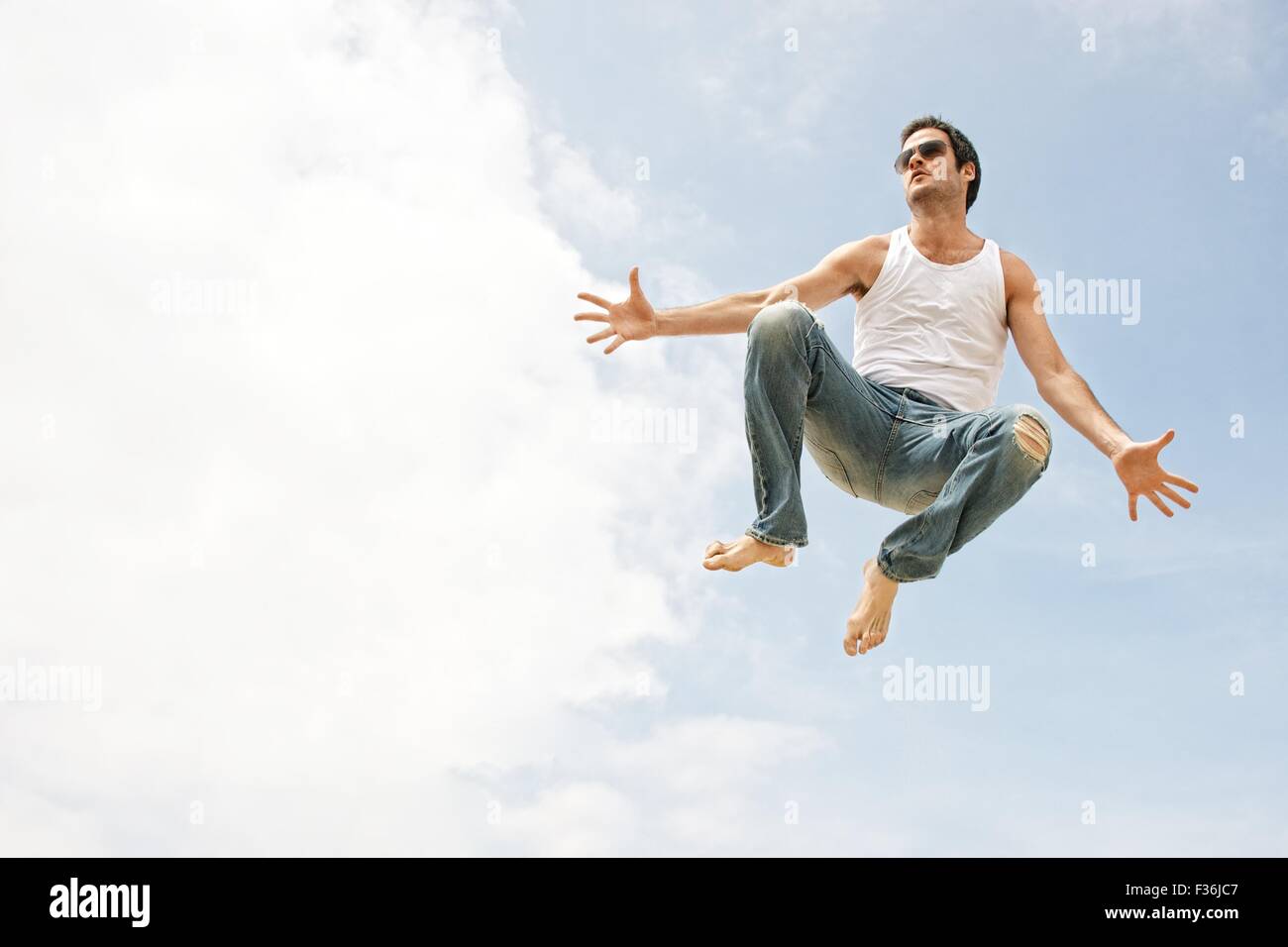 Man jumping against blue sky Stock Photo - Alamy
