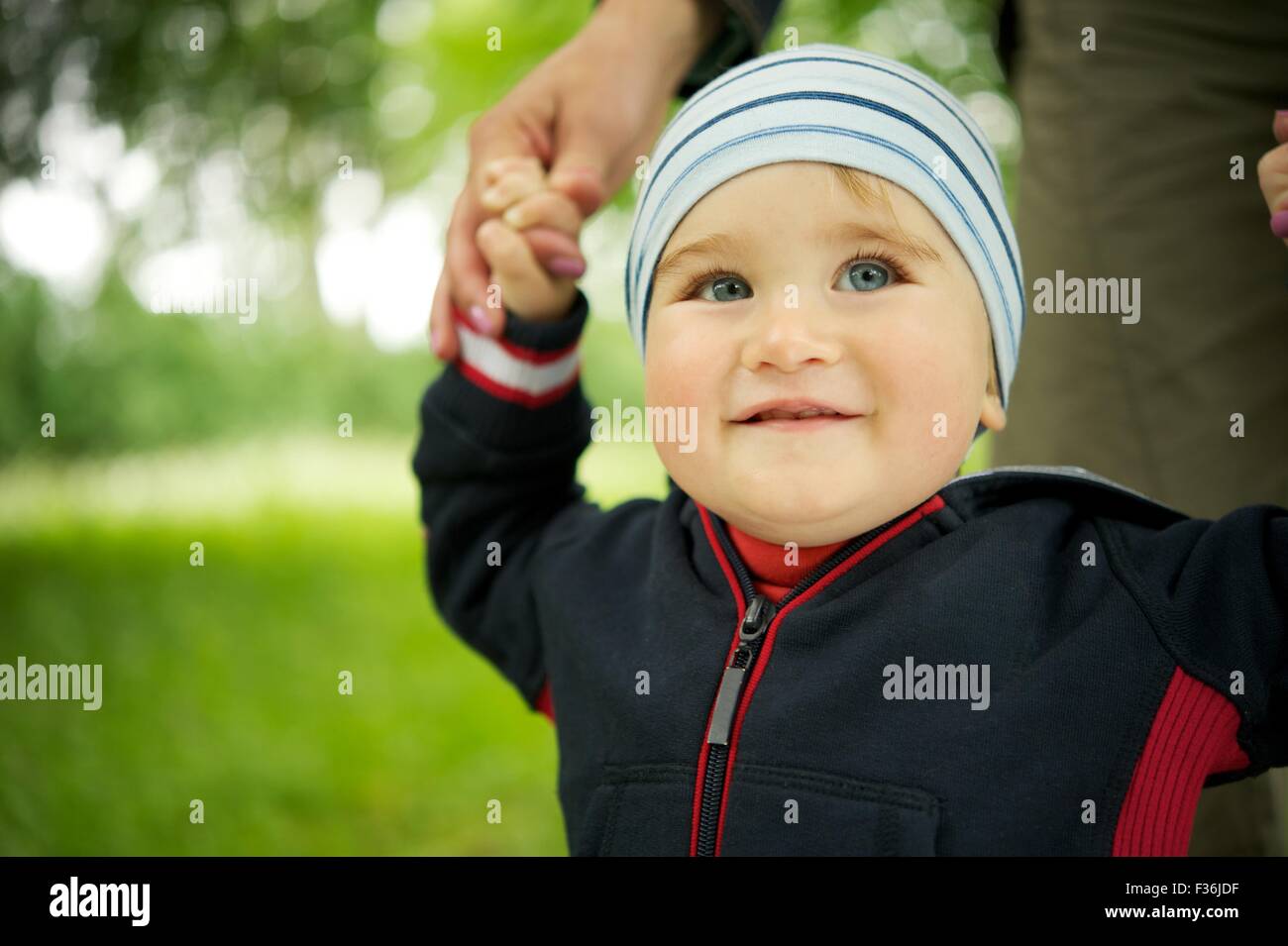 Smiling baby standing outdoors Stock Photo - Alamy