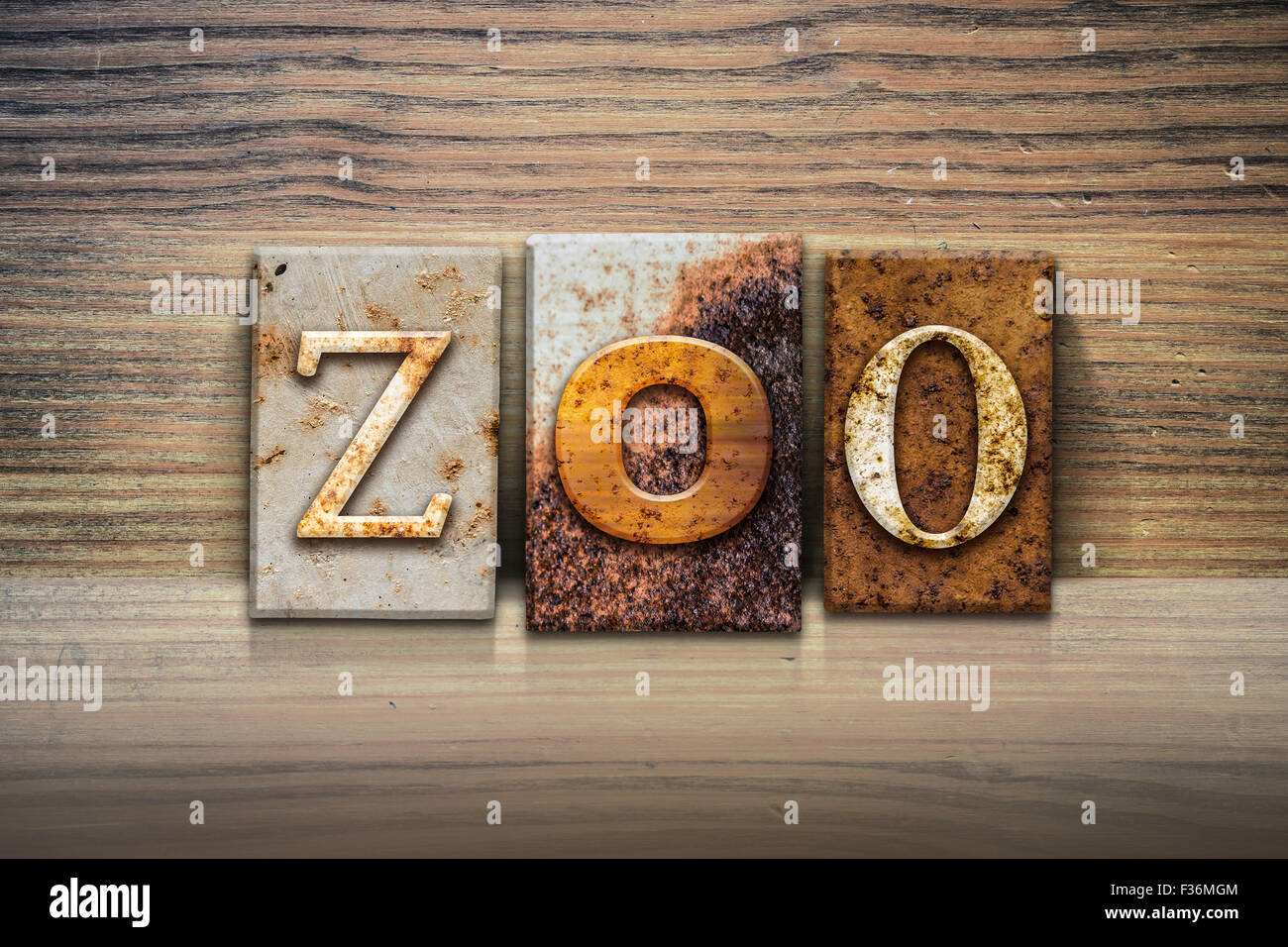 The word "ZOO" written in rusty metal letterpress type sitting on a ...