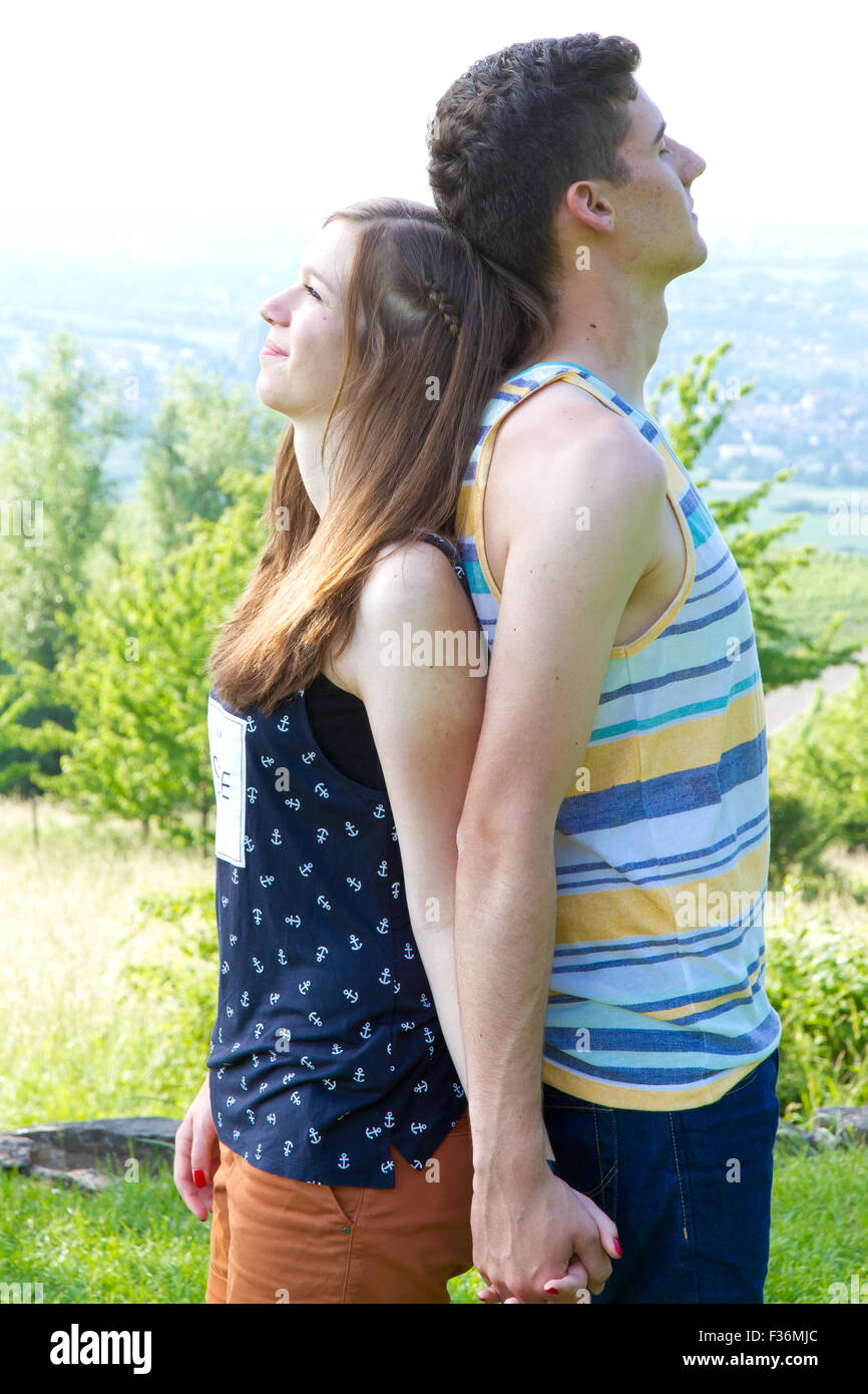 Young love couple back on back Stock Photo - Alamy