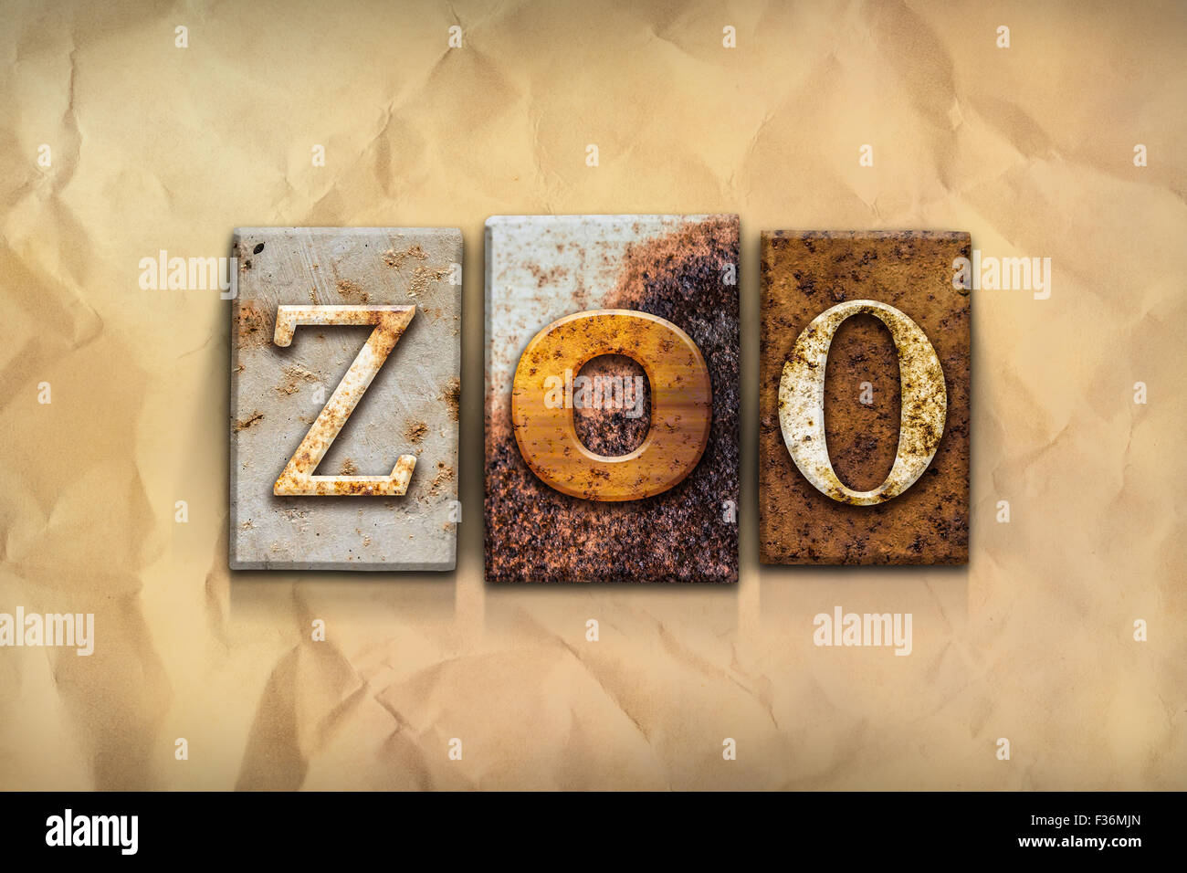 The word "ZOO" written in rusty metal letterpress type on a crumbled ...