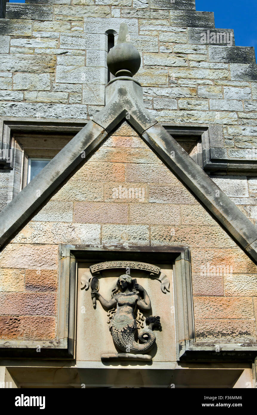 Interesting carved stone crest featuring a mermaid looking in a mirror ...