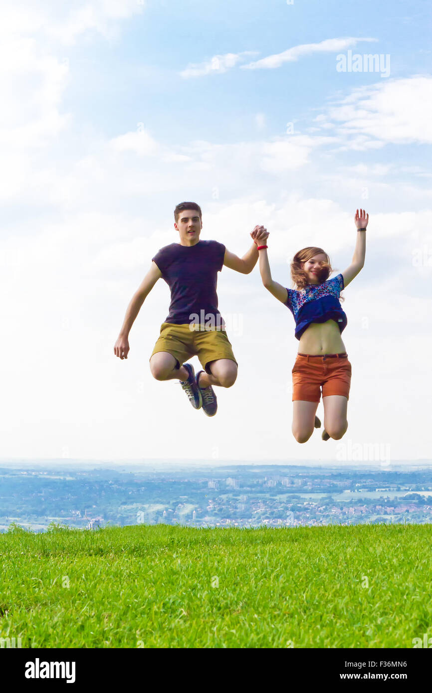 Young couple jumping high in the air Stock Photo - Alamy