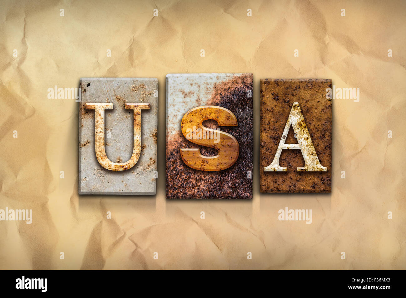 The word "USA" written in rusty metal letterpress type on a crumbled ...