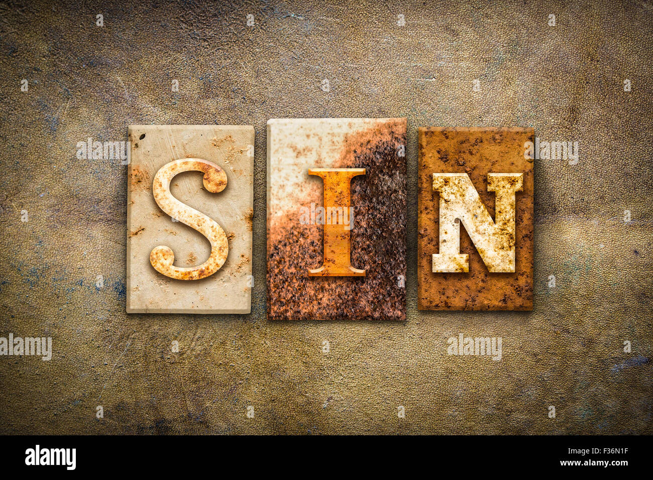 The word "SIN" written in rusty metal letterpress type on an old aged ...