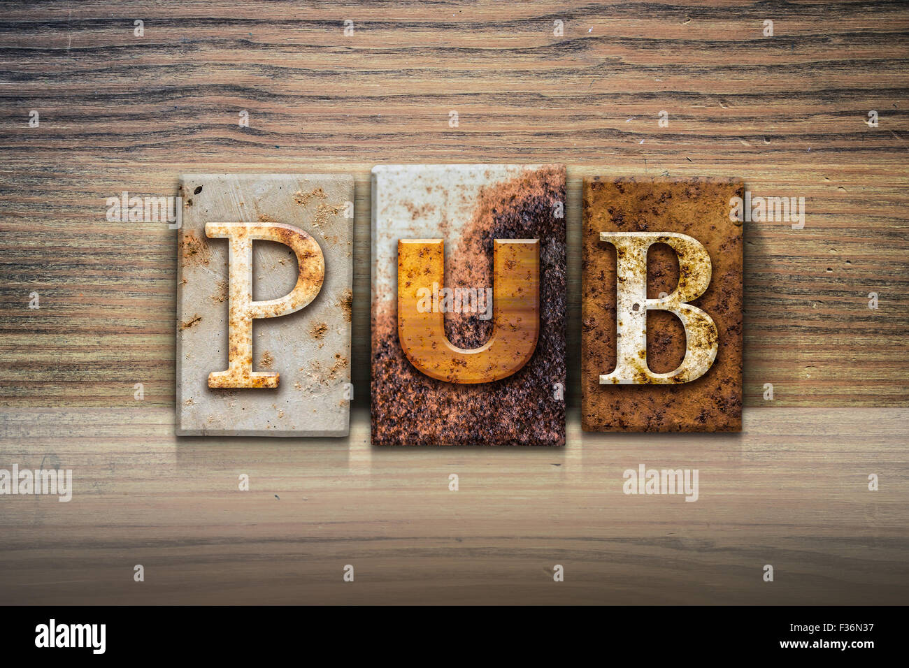 The word "PUB" written in rusty metal letterpress type sitting on a ...
