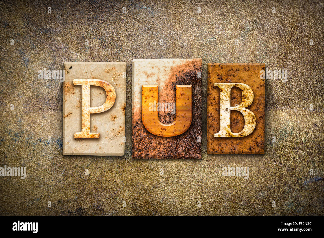 The word "PUB" written in rusty metal letterpress type on an old aged ...
