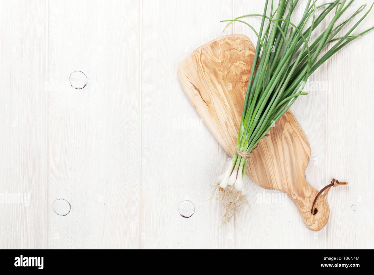 Fresh garden spring onion on cutting board. Top view with copy space ...