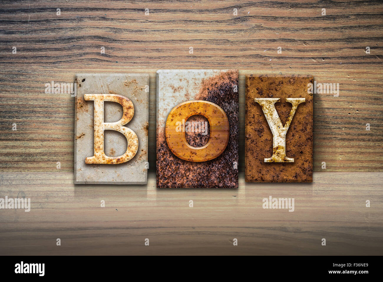 The word "BOY" written in rusty metal letterpress type sitting on a ...