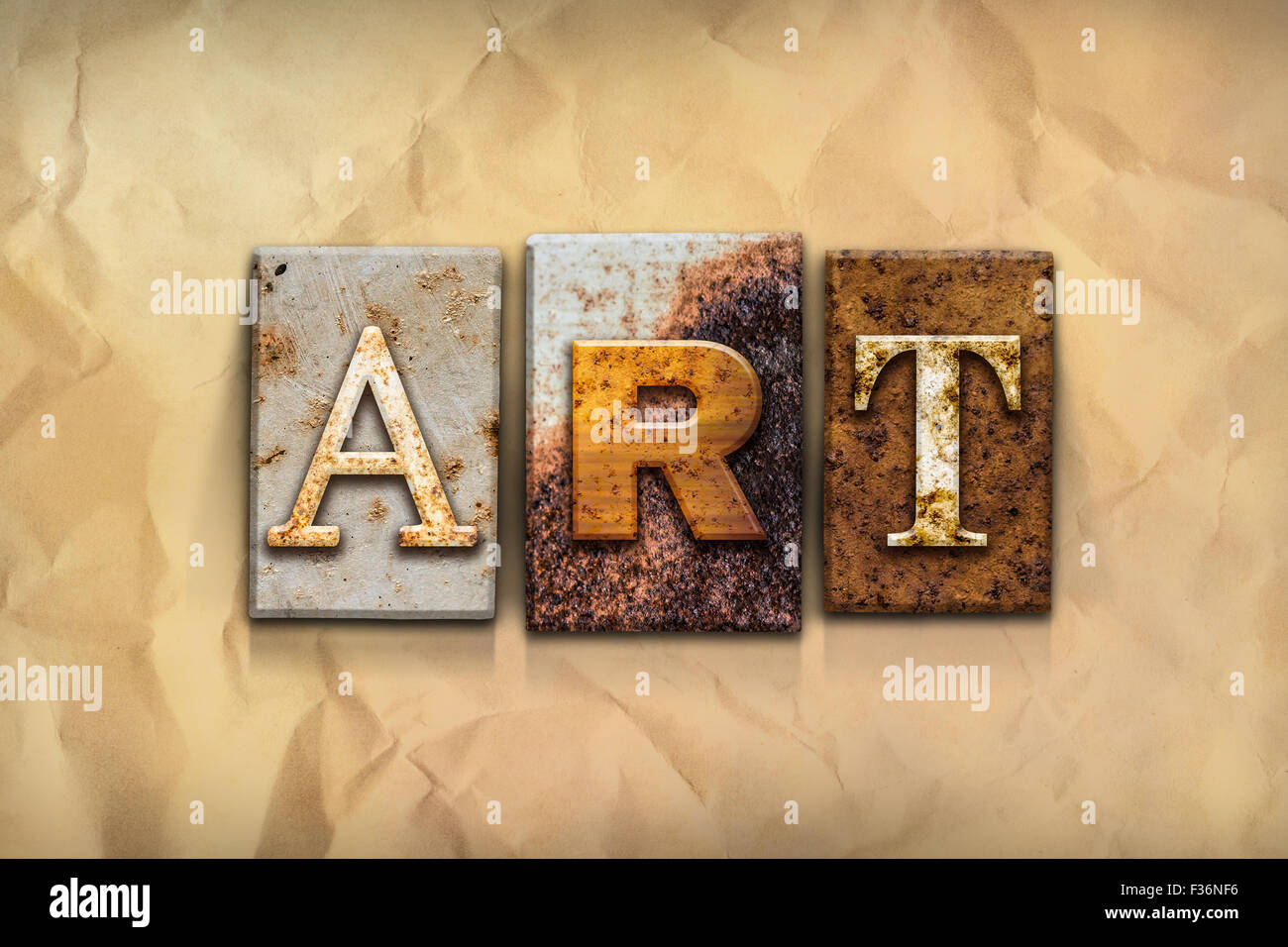 The word "ART" written in rusty metal letterpress type on a crumbled ...
