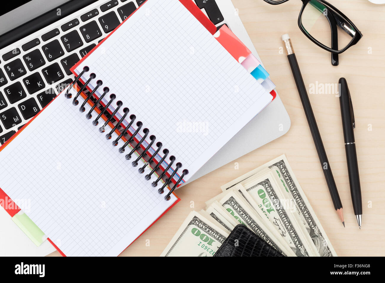 Office table with pc, supplies and money cash. View from above with ...