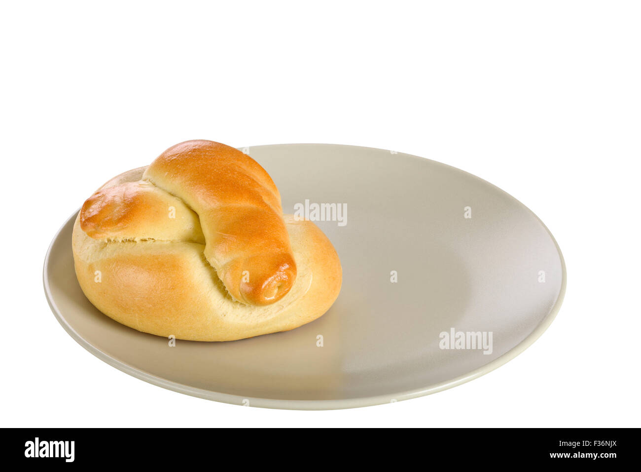 Bread roll on ceramic plate, isolated on white background Stock Photo ...