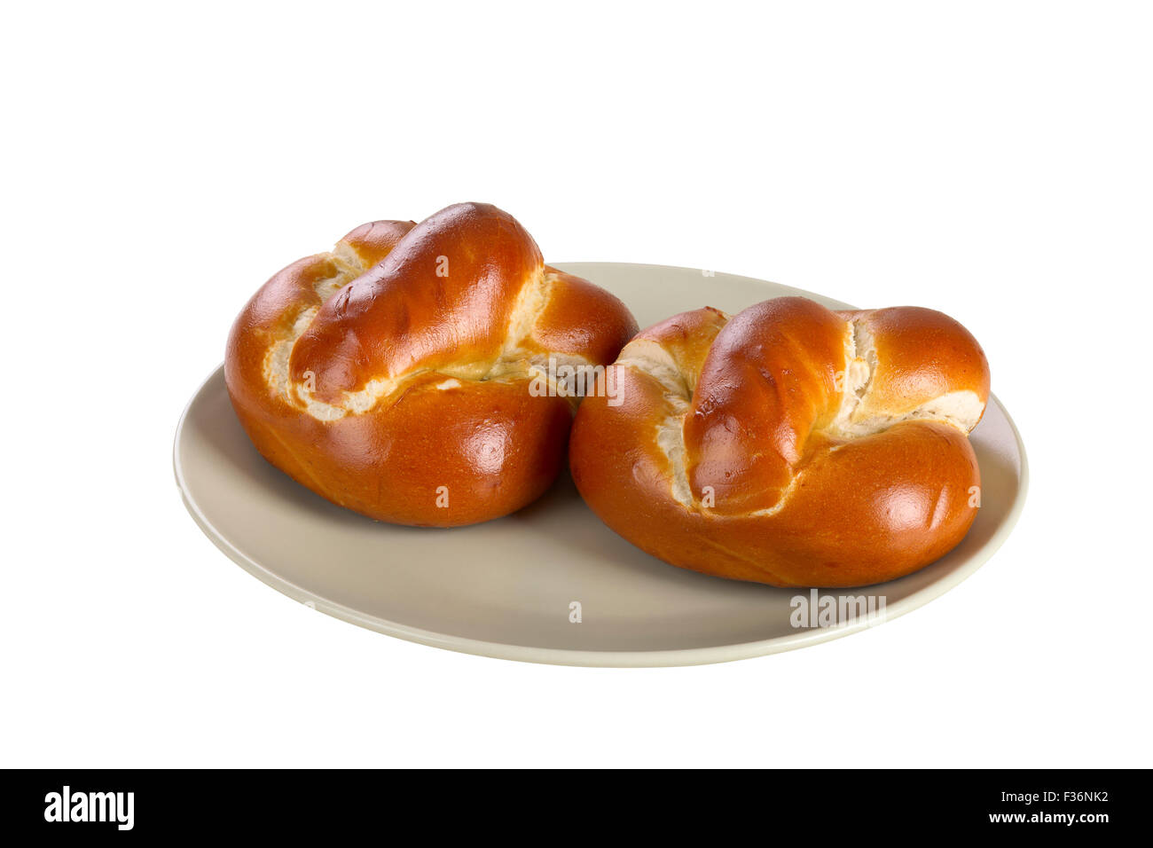 Bread roll on ceramic plate, isolated on white background Stock Photo ...