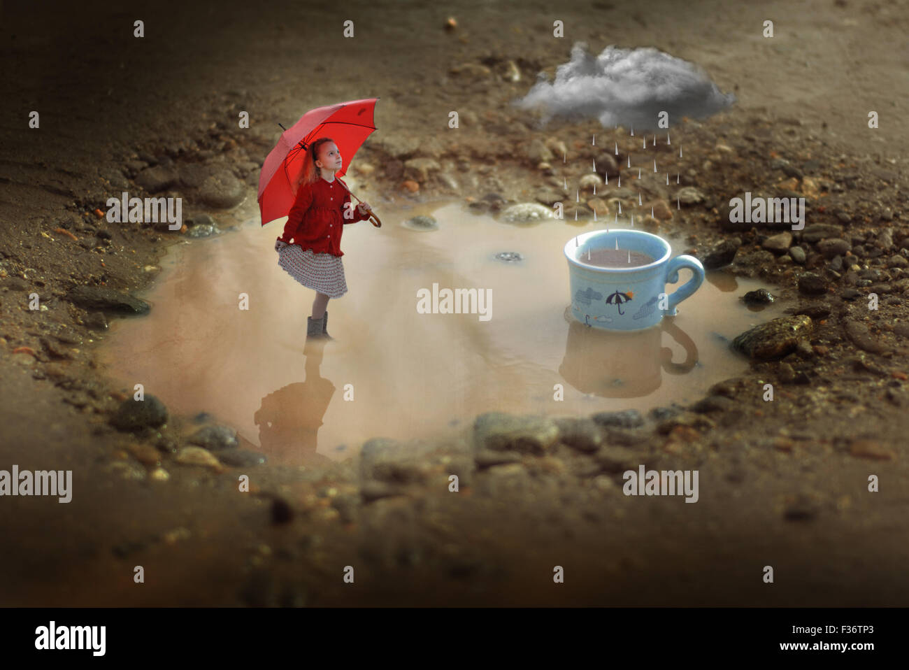 Miniature girl standing in a puddle with a red umbrella with a big ...