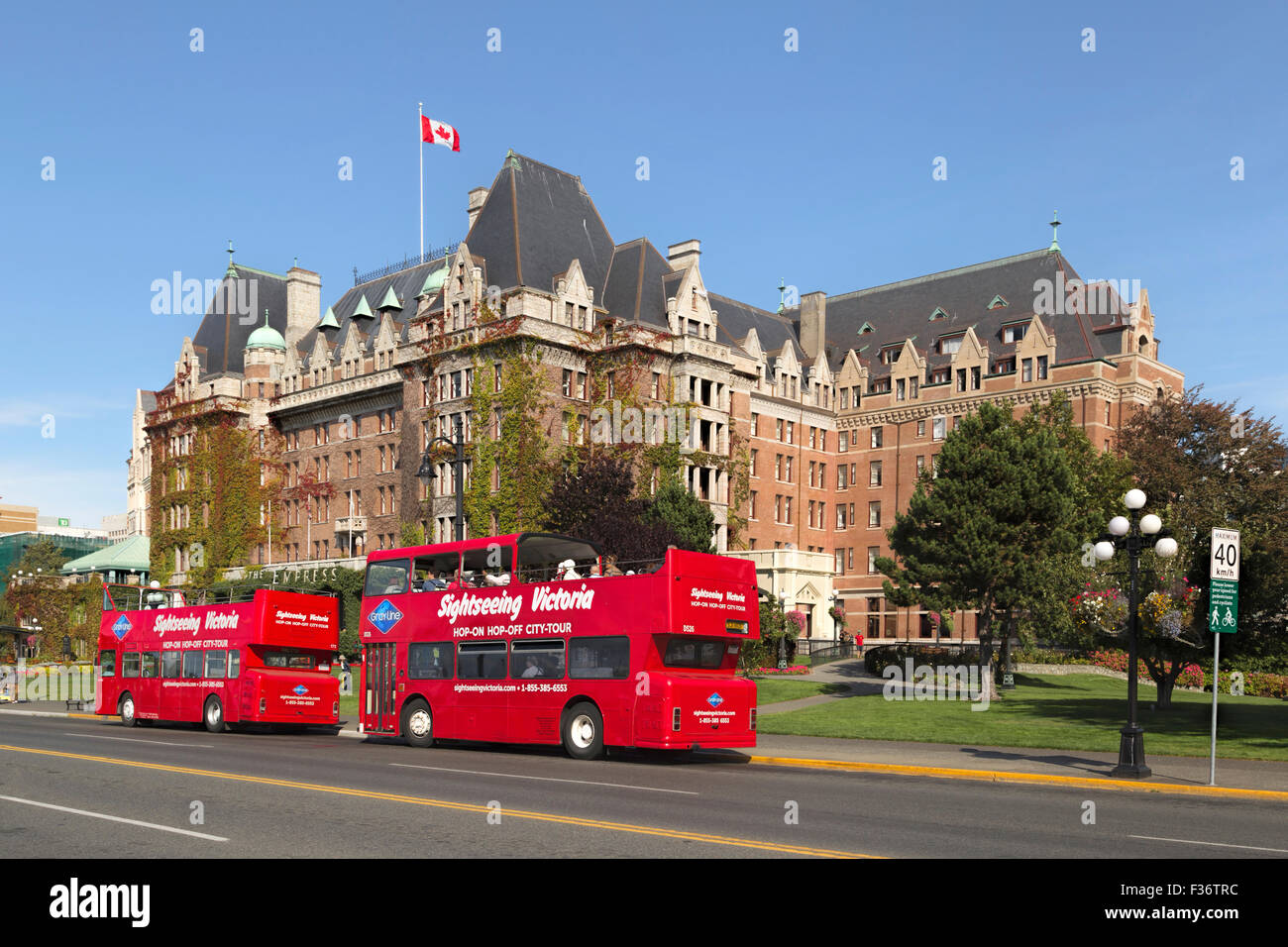 Double-decker buses stop at the Fairmont Empress Hotel, a landmark in ...