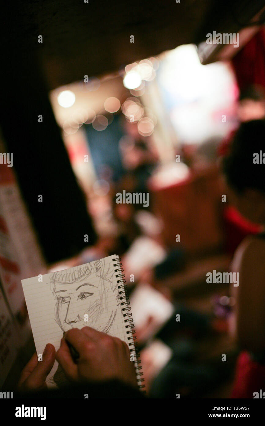 Artist illustrator drawing a picture with pen pencil Stock Photo - Alamy