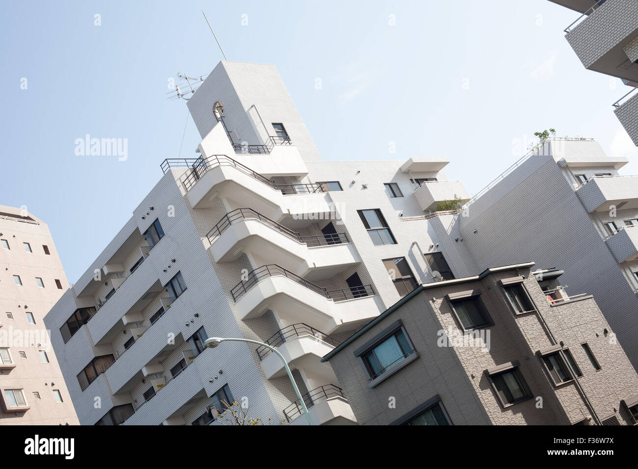 White modern apartment building from below angled Stock Photo - Alamy
