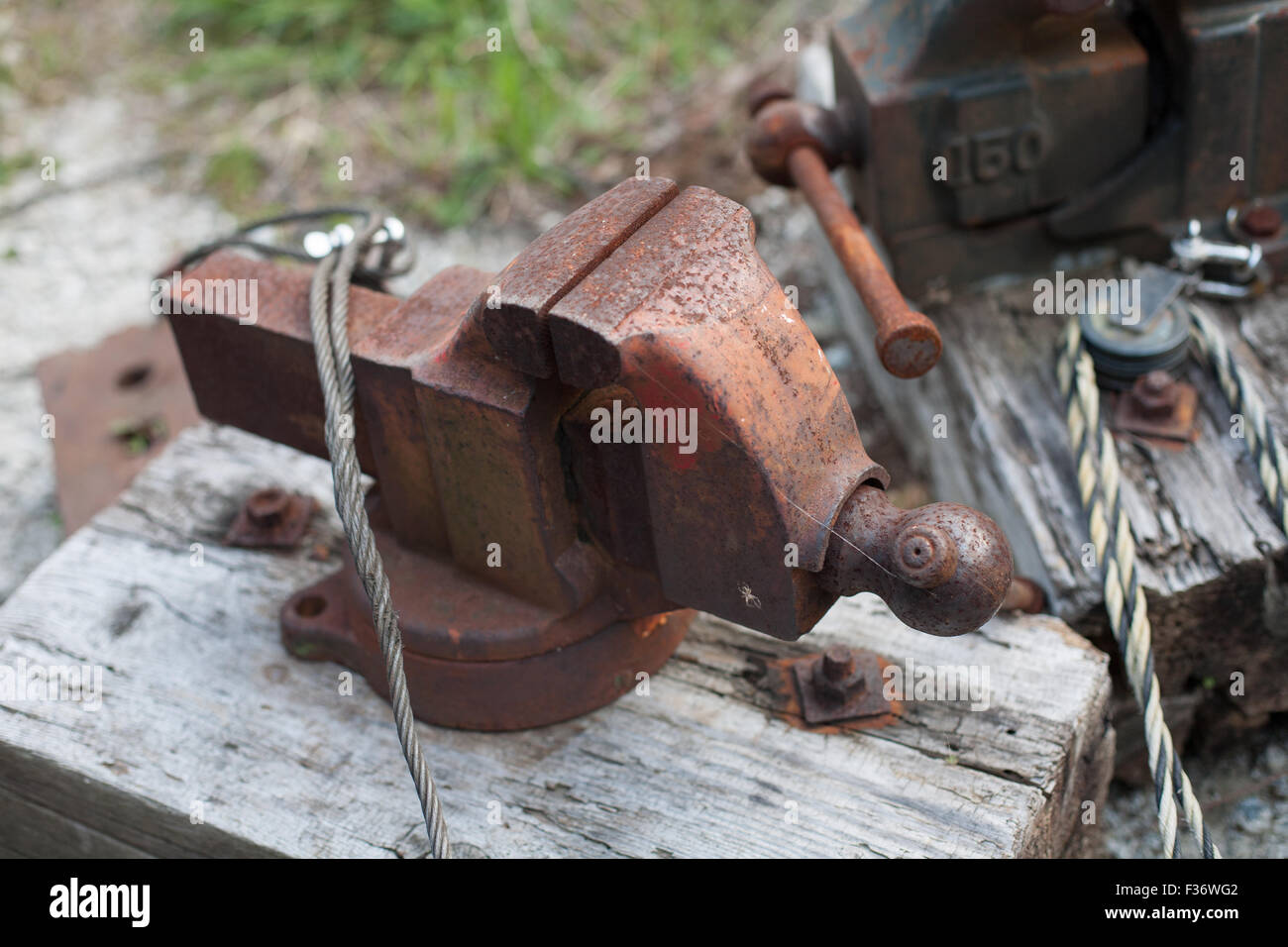 Old rusty vice on a weathered wooden block Stock Photo - Alamy