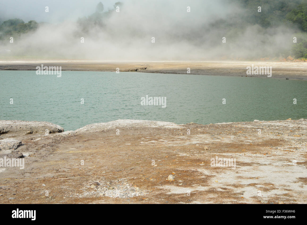 The crater of Tecapa volcano with a little sulpher lagoon, near the ...
