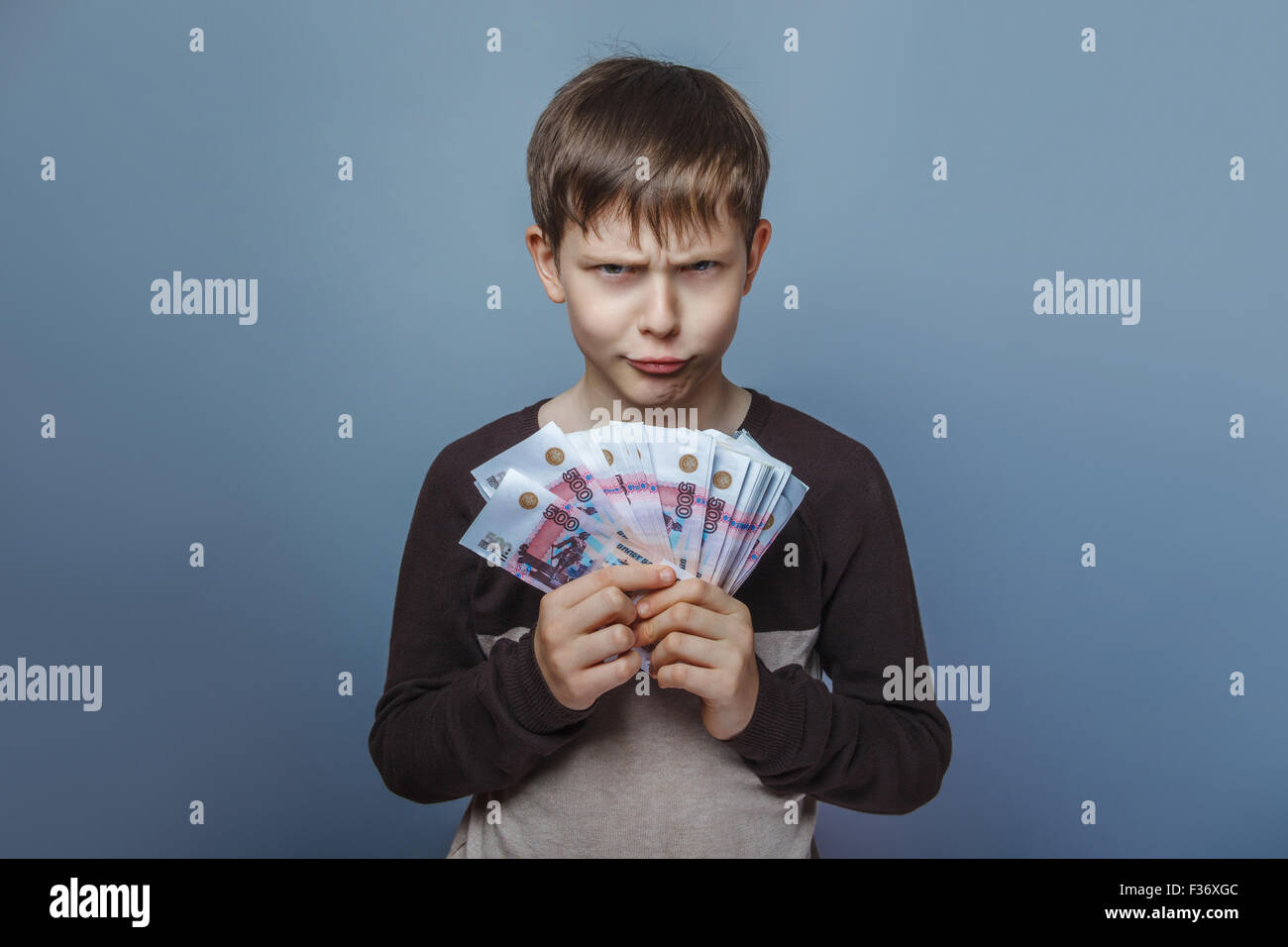Boy teenager European appearance ten years holding a wad of mo Stock ...