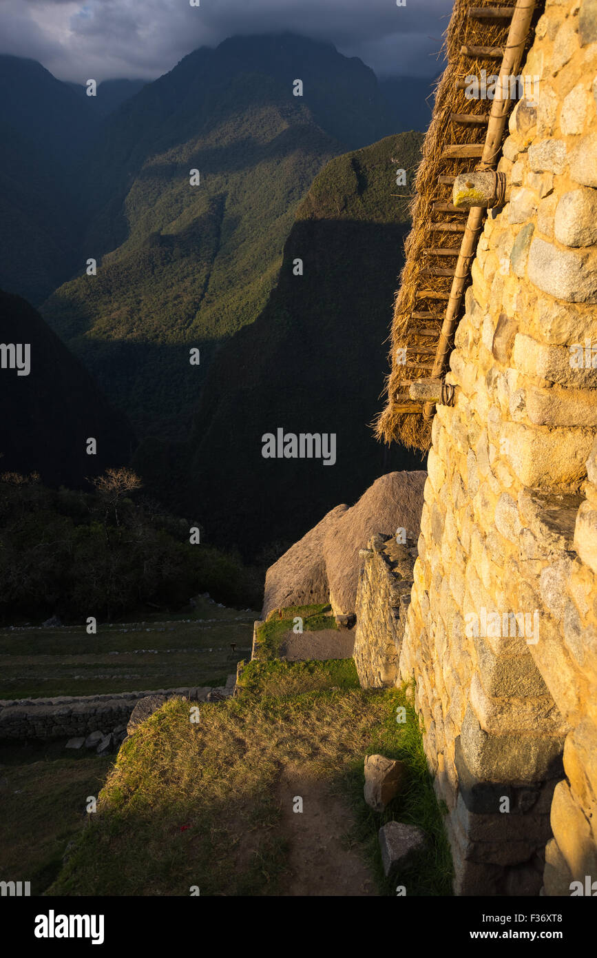 Machu Picchu building details illuminated by the last sunlight. Wide ...