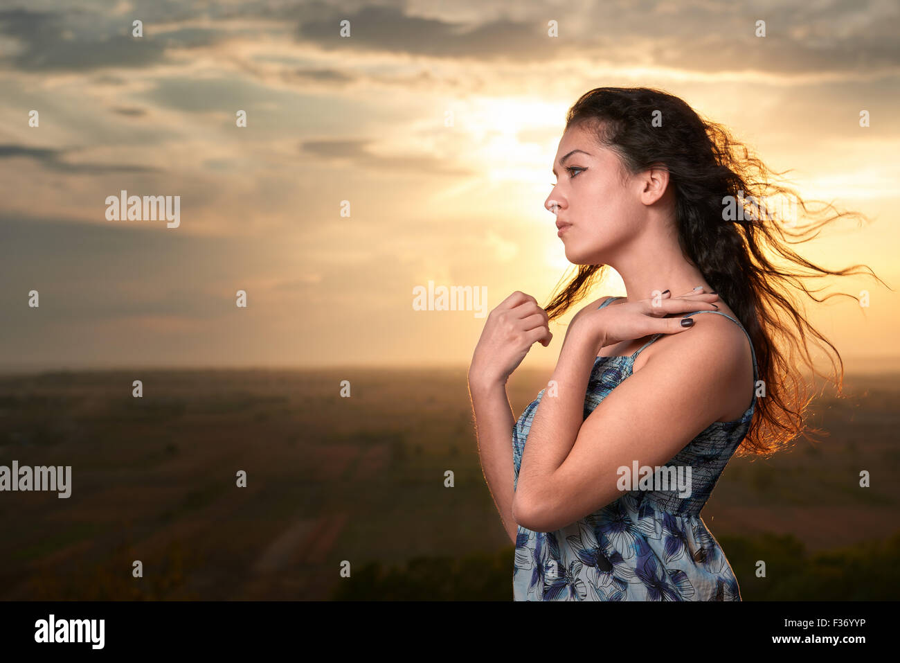 portrait of a girl at sunset on field background Stock Photo - Alamy