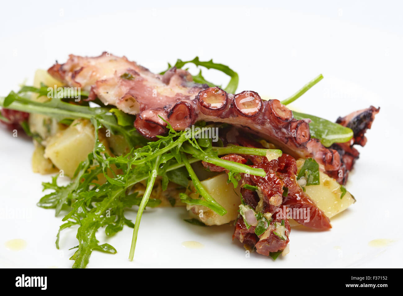 octopus with potatoes, arugula Stock Photo - Alamy