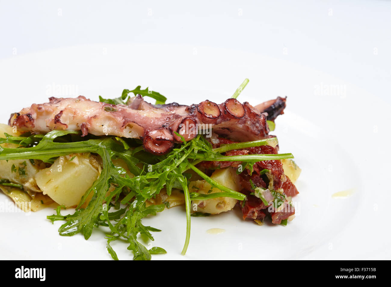 octopus with potatoes, arugula Stock Photo - Alamy