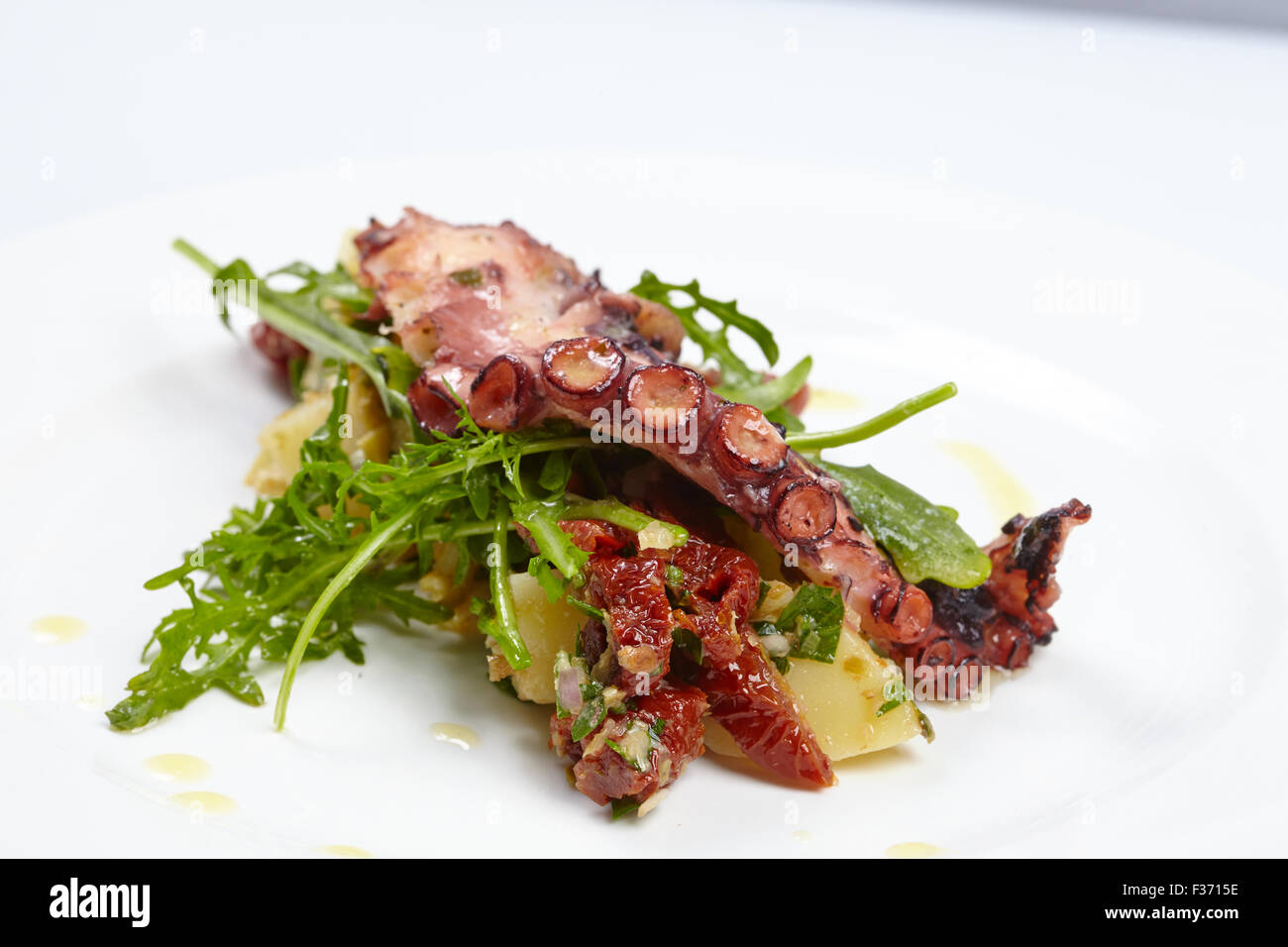 octopus with potatoes, arugula Stock Photo - Alamy