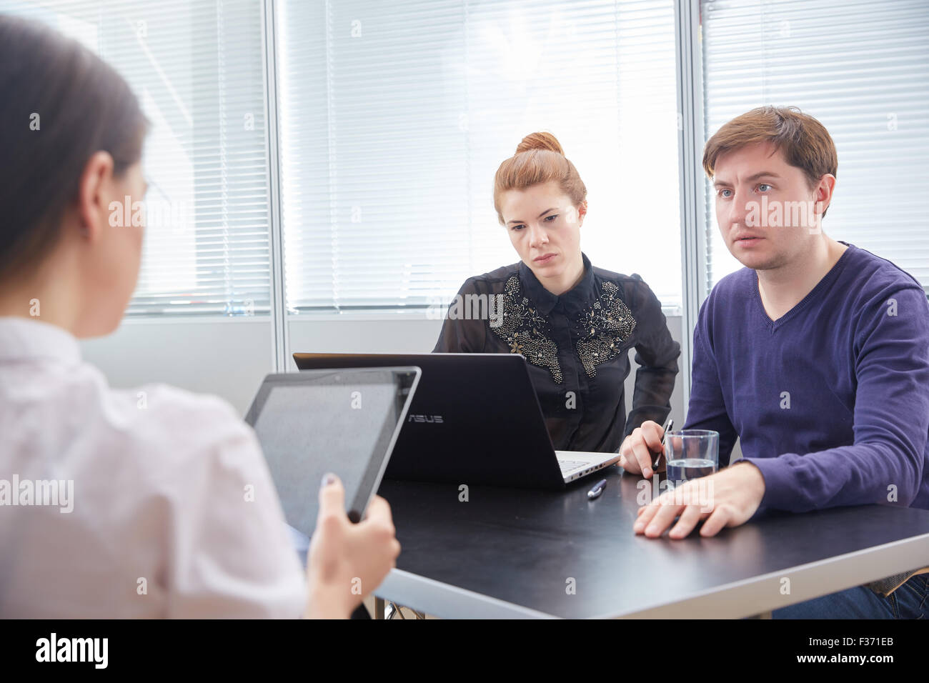 Three businessmen discussing something together Stock Photo - Alamy