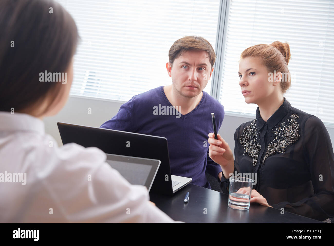 Three businessmen discussing something together Stock Photo - Alamy