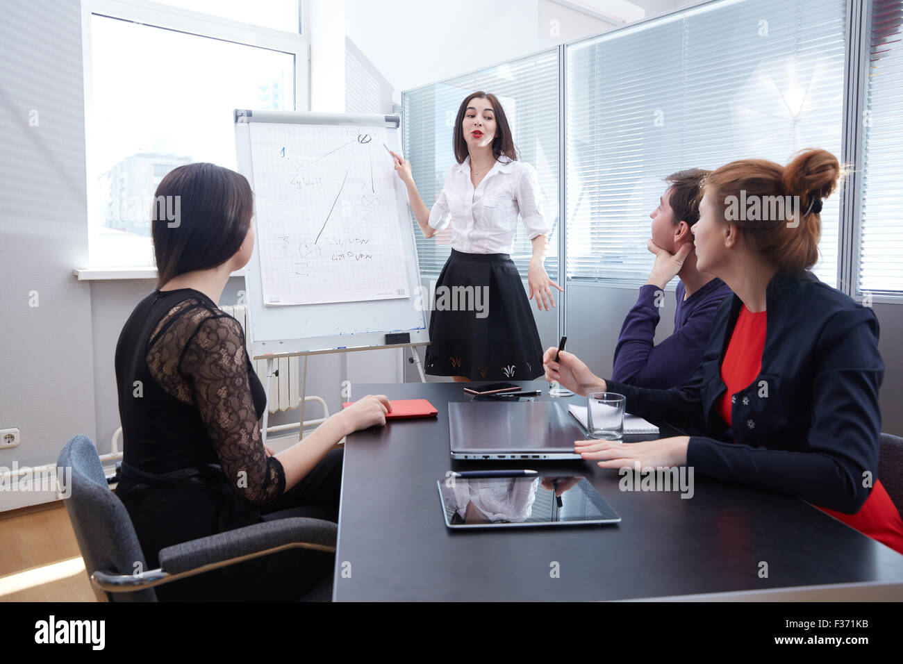 a group of businessmen in a meeting looking at the board Stock Photo ...