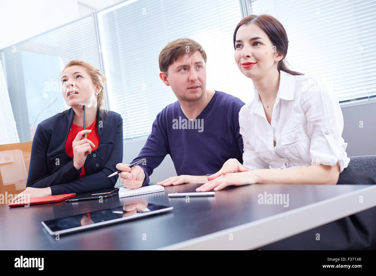 Three businessmen discussing something together Stock Photo - Alamy