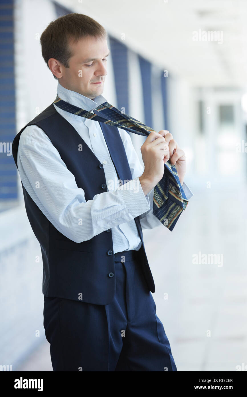 Handsome businessman fixing his tie hi-res stock photography and images ...