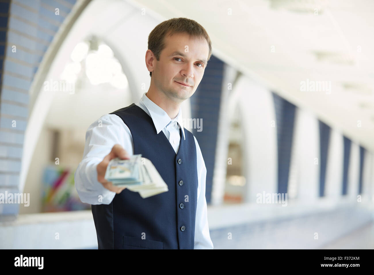 businessman holding money Stock Photo - Alamy