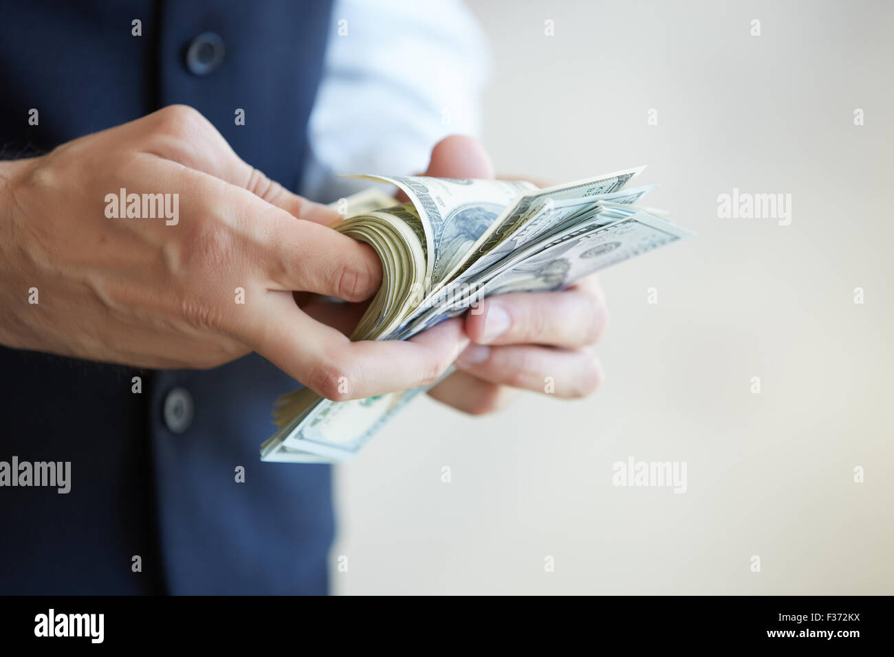 businessman holding money Stock Photo - Alamy