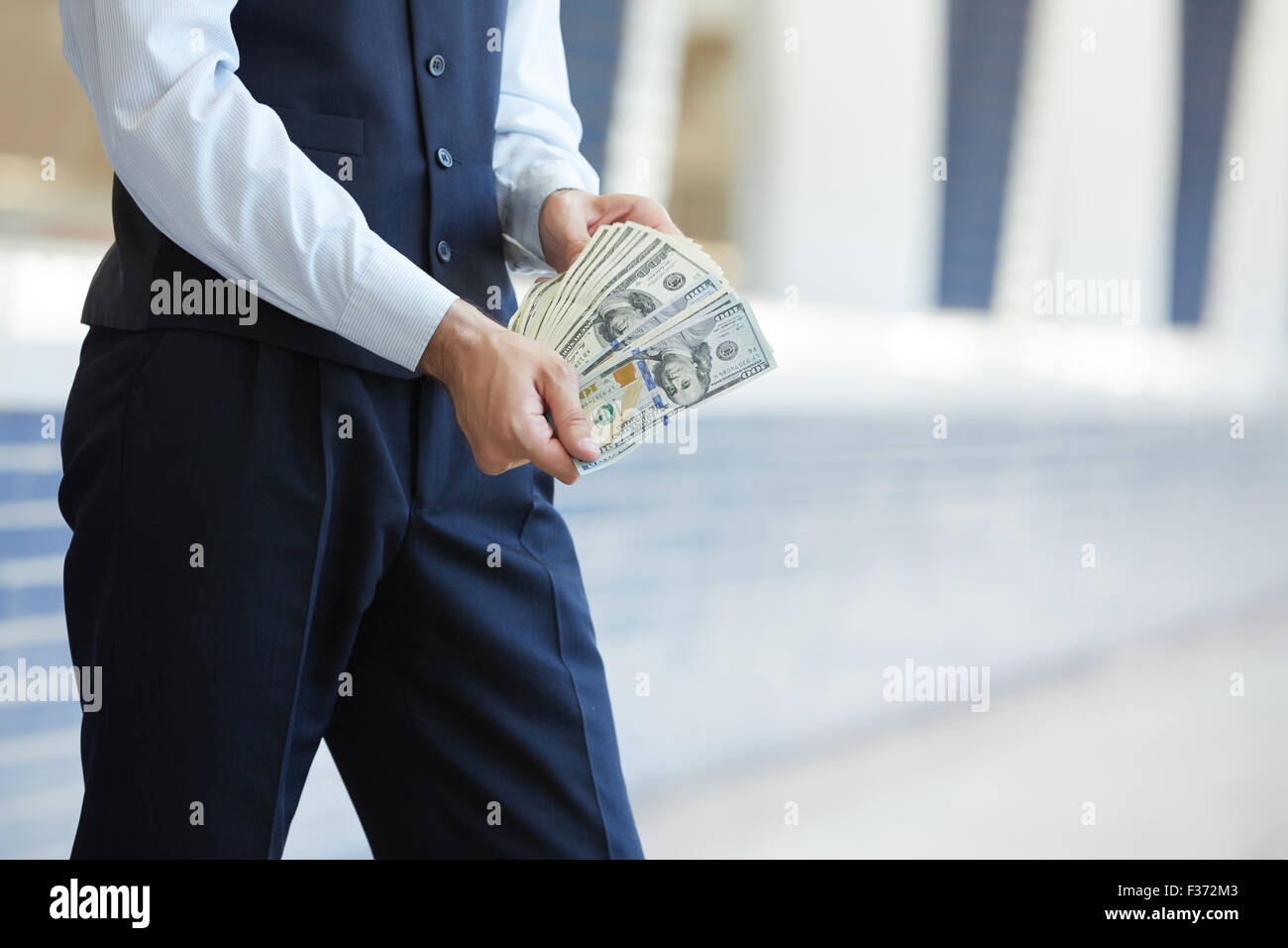 businessman holding money Stock Photo - Alamy