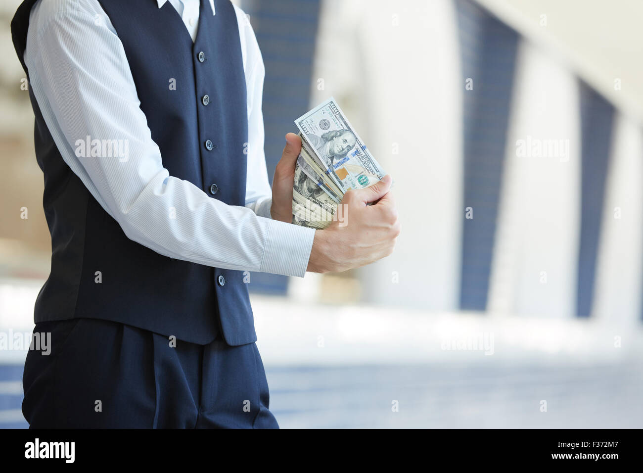 businessman holding money Stock Photo - Alamy