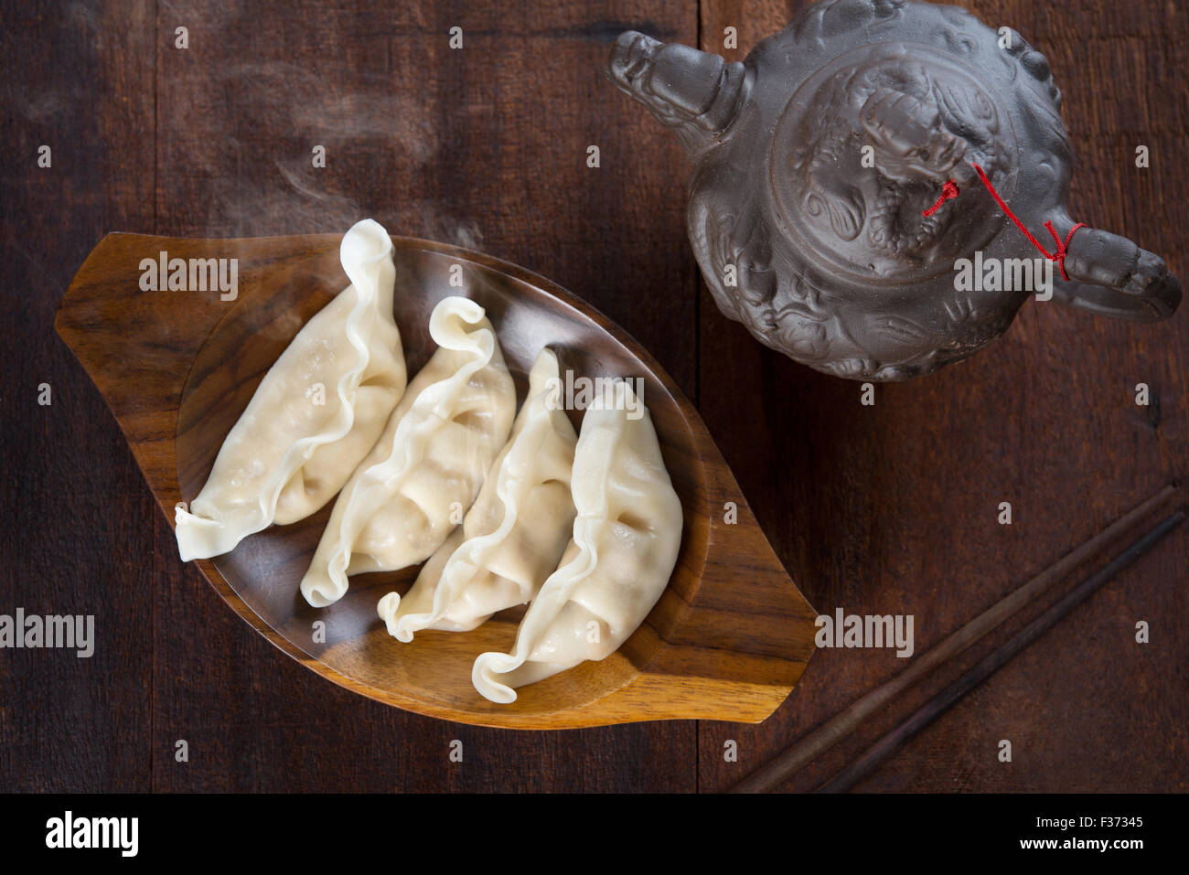 Top view fresh dumpling on wood plate with hot steams. Chinese dish on ...