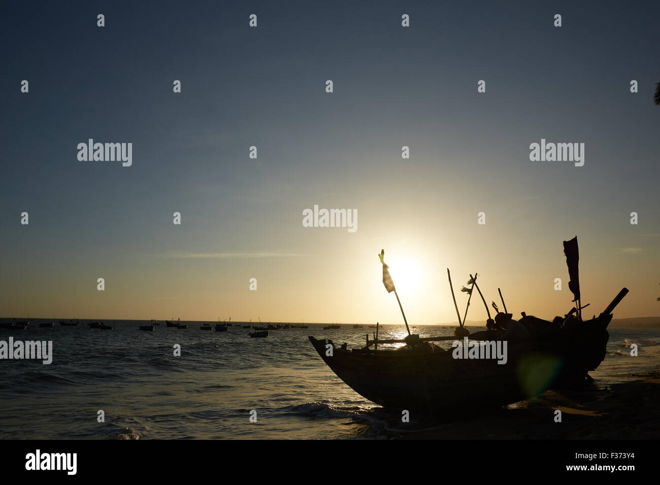 Fishing boats at sunset Stock Photo - Alamy