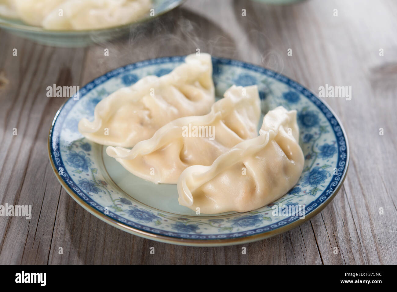 Fresh dumpling on plate. Chinese cuisine with hot steams on vintage ...