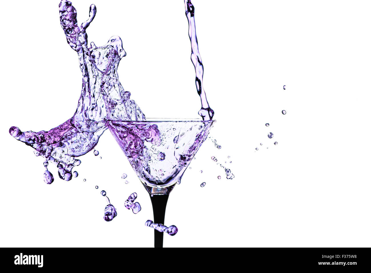 Abstract art. Cocktail glass with splashes of liquid isolated on a ...