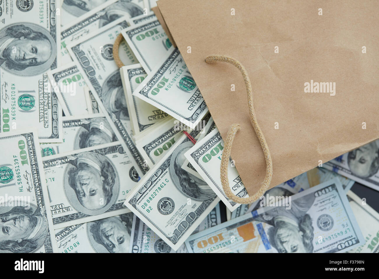 a lot of money out of a paper bag Stock Photo - Alamy
