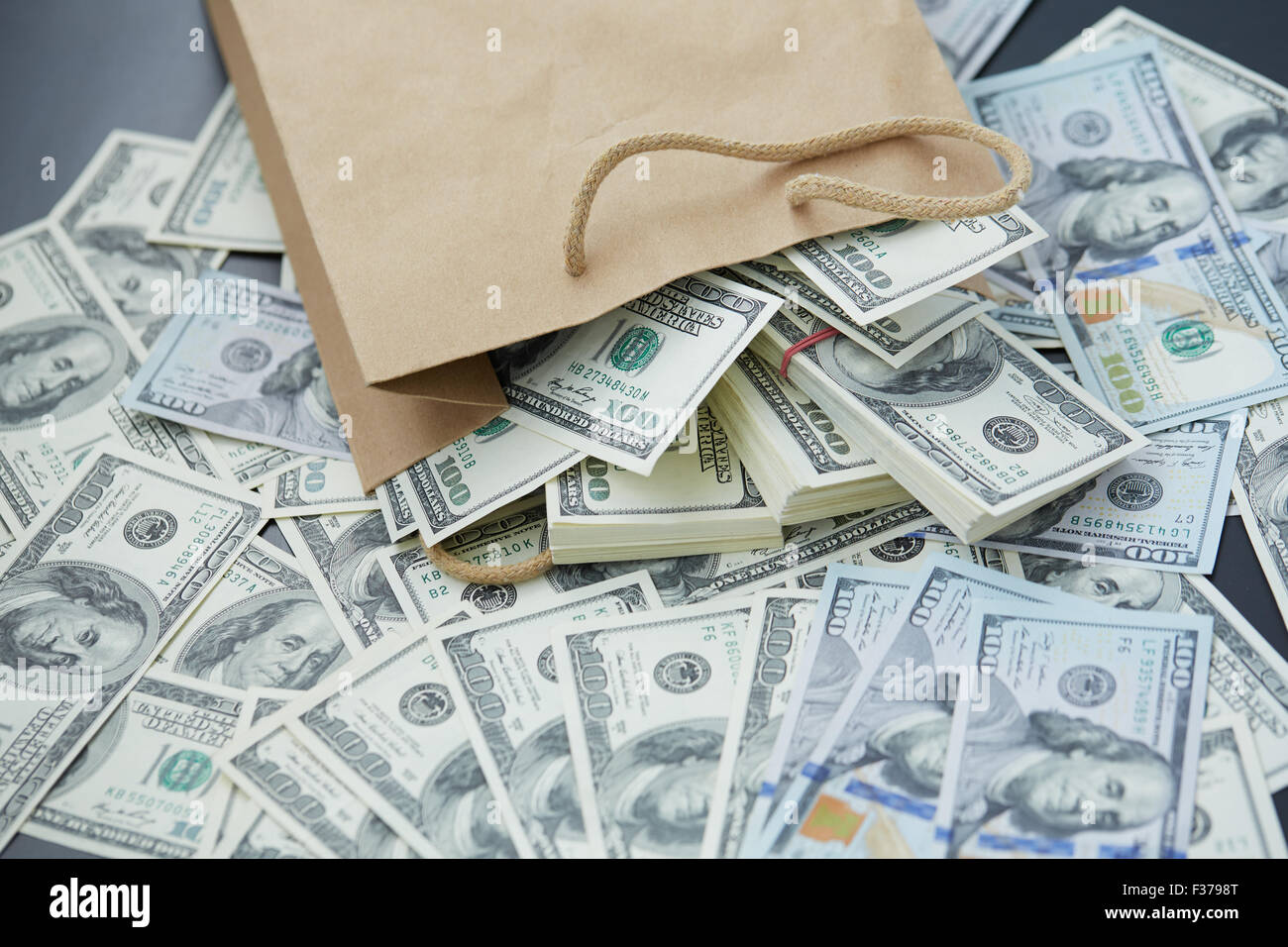 a lot of money out of a paper bag Stock Photo - Alamy