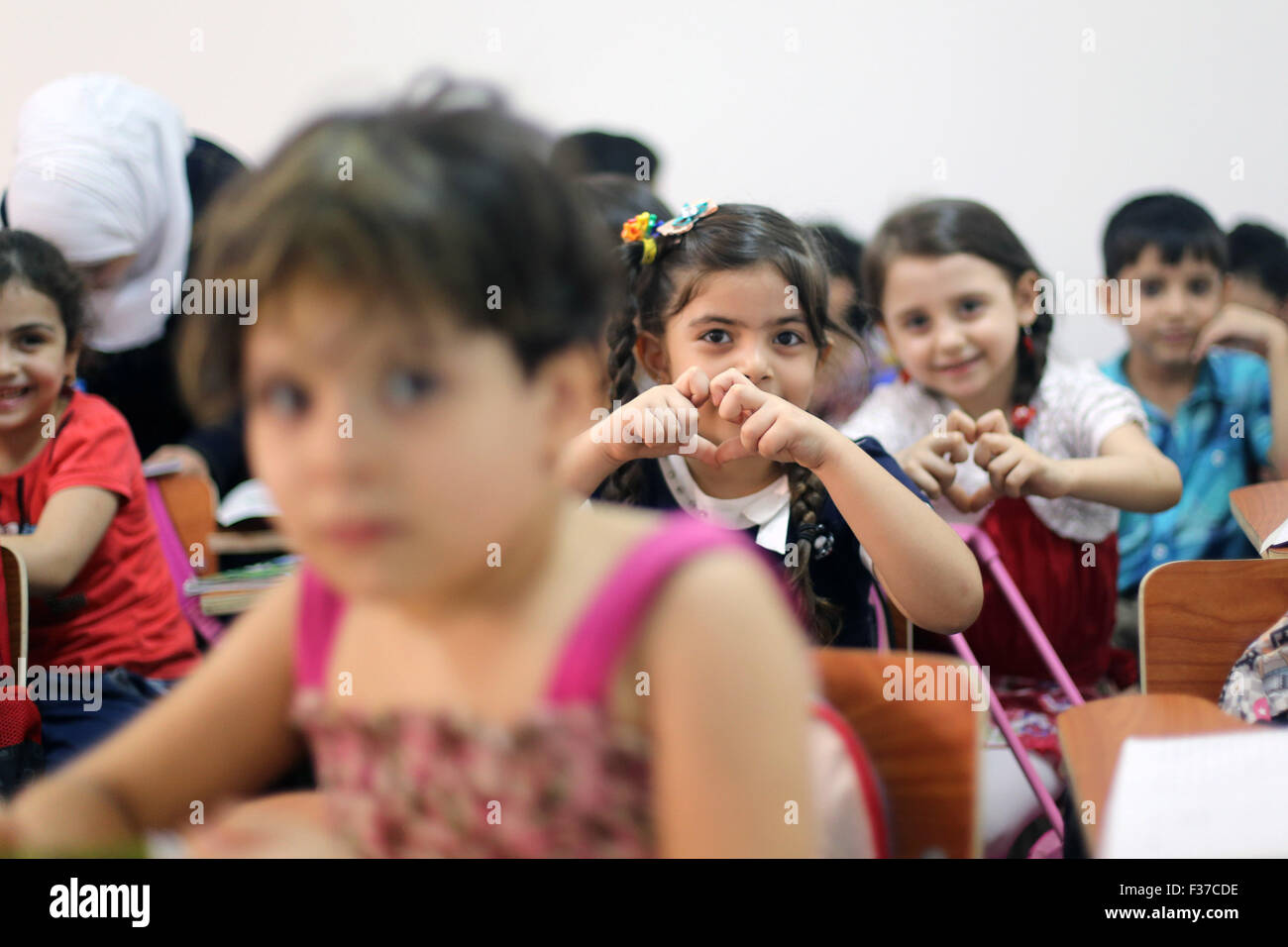 Cairo, Egypt. 30th Sep, 2015. Syrian students gesture during a class at ...