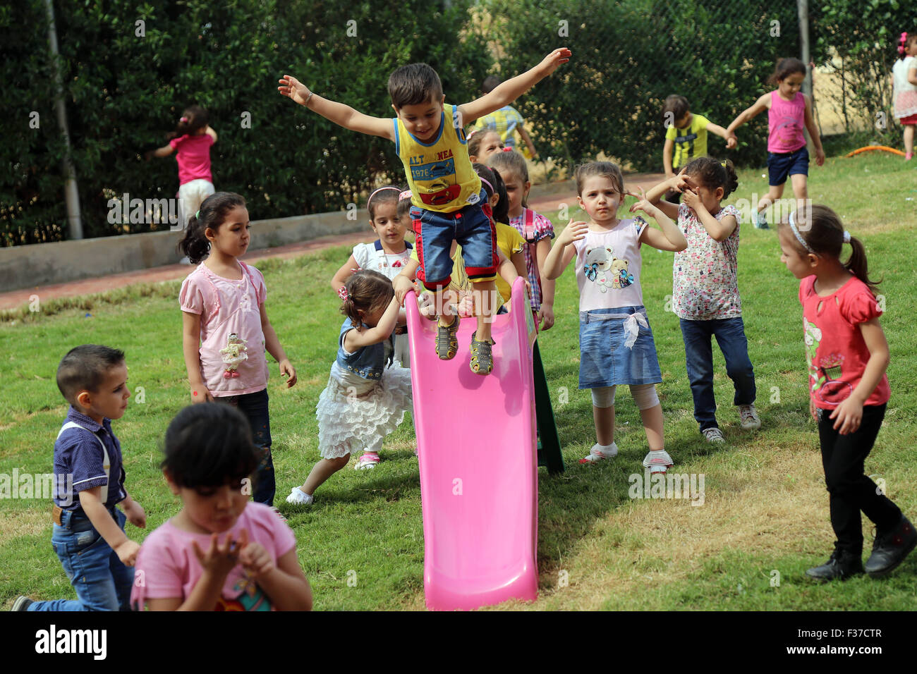 Cairo, Egypt. 30th Sep, 2015. Syrian kids have fun on the playground ...
