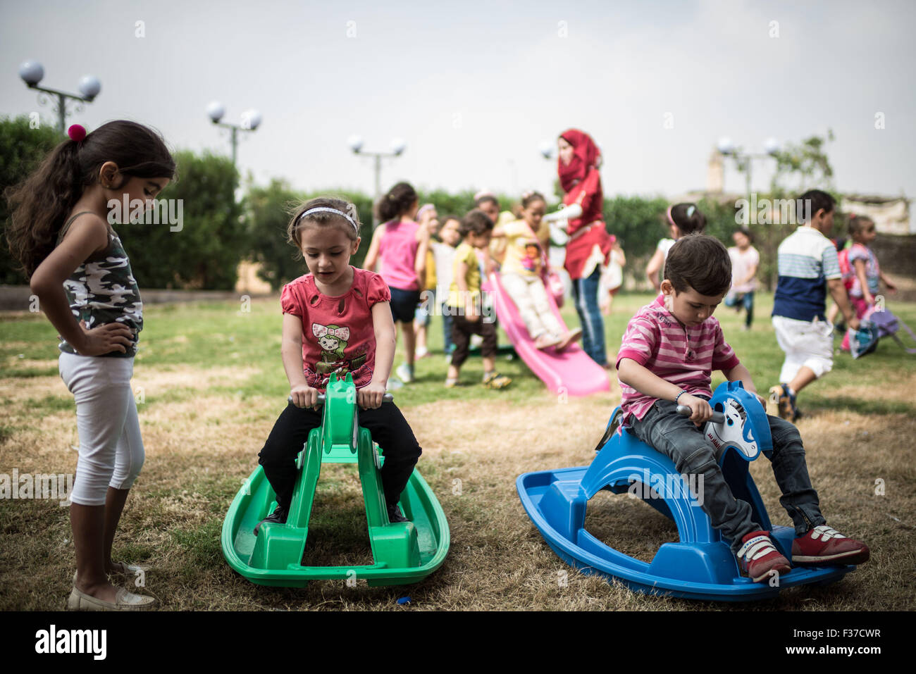 Cairo, Egypt. 30th Sep, 2015. Syrian kids have fun on the playground ...