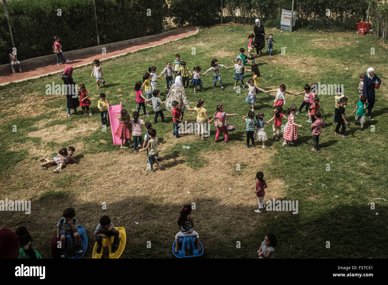 Cairo, Egypt. 30th Sep, 2015. Syrian kids have fun on the playground ...