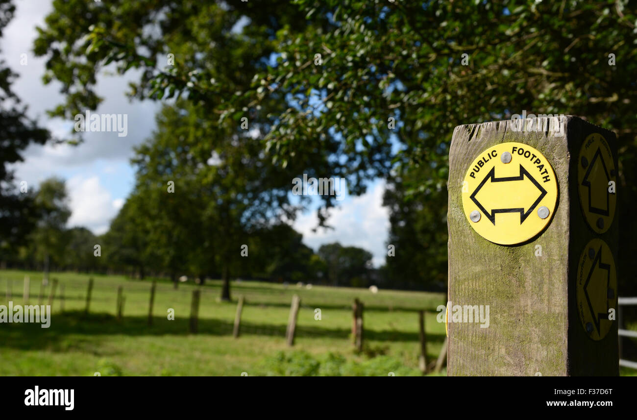 Public footpath sign on a post points left and right in the countryside ...