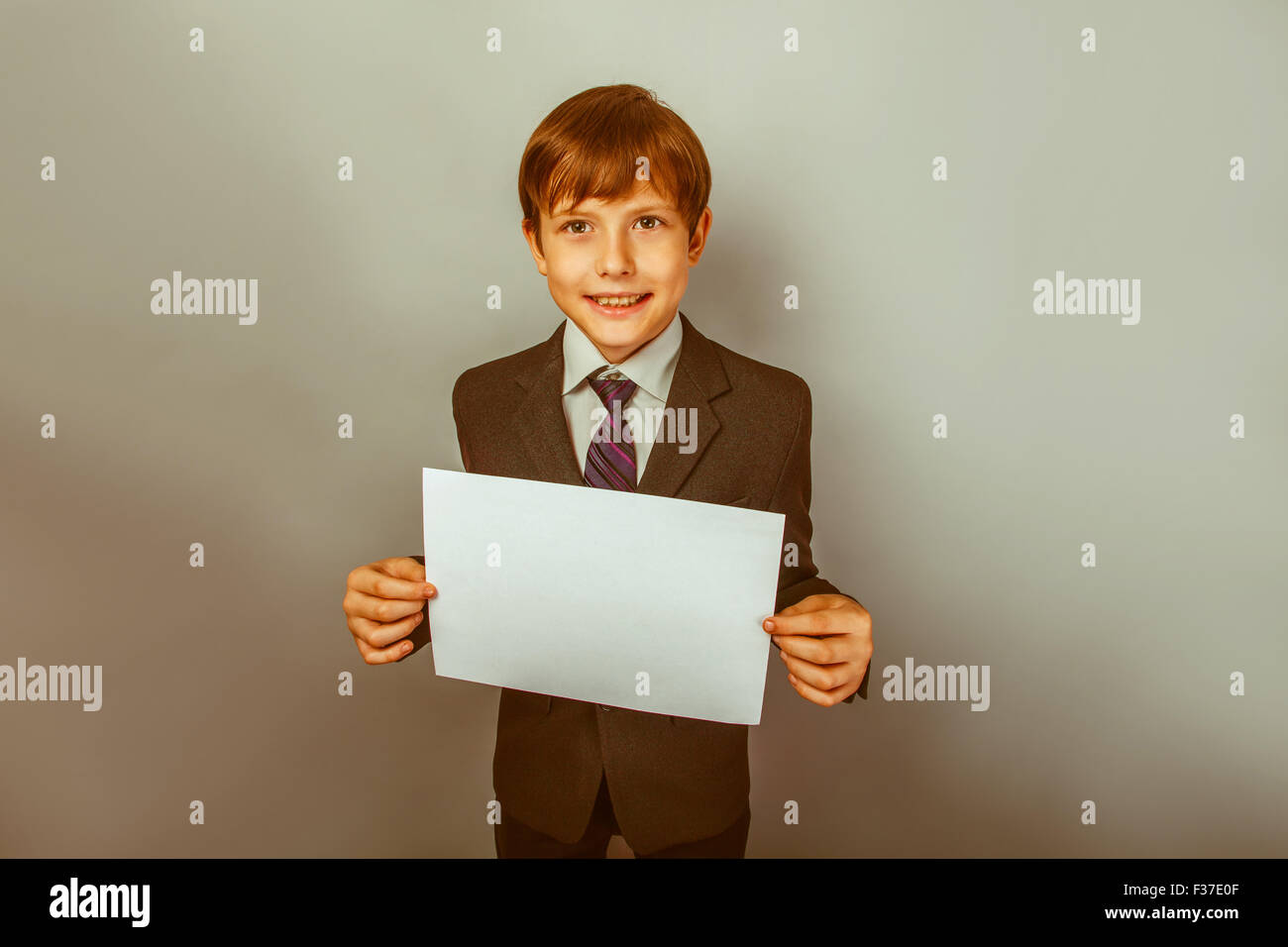 a boy of twelve European appearance in a suit holding a blank sh Stock ...